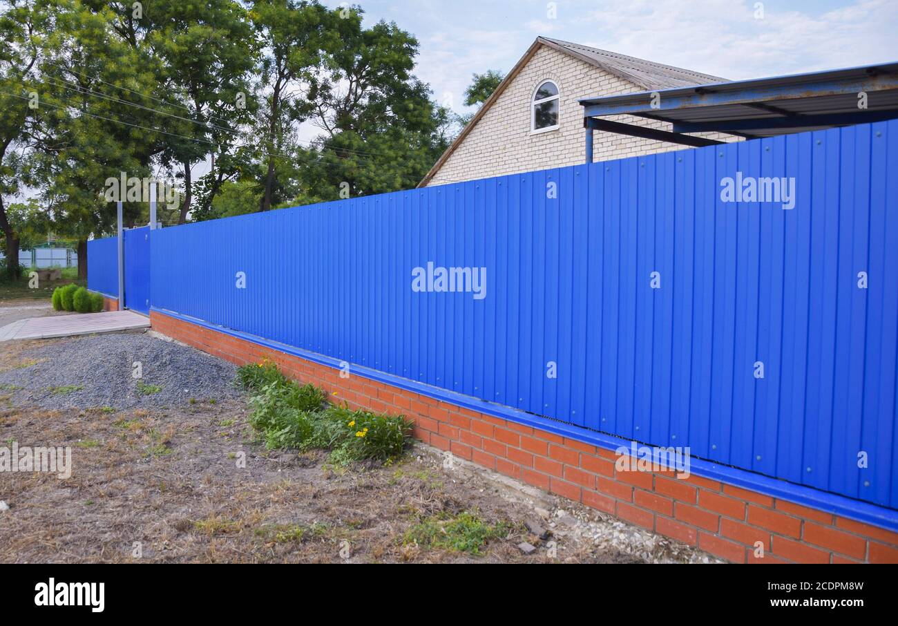 Blue gate and fence Stock Photo - Alamy