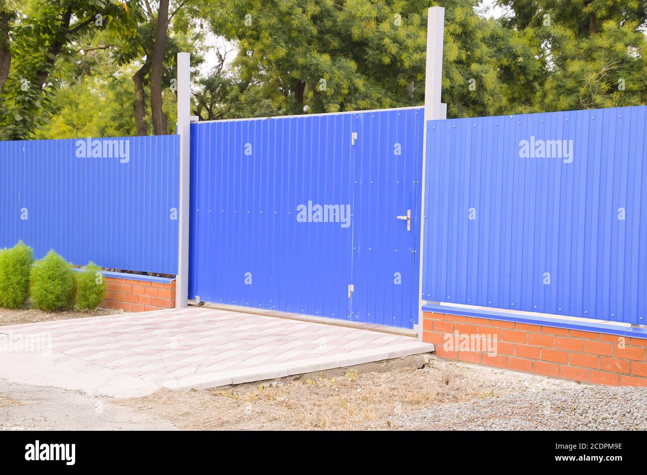 Blue gate and fence Stock Photo - Alamy