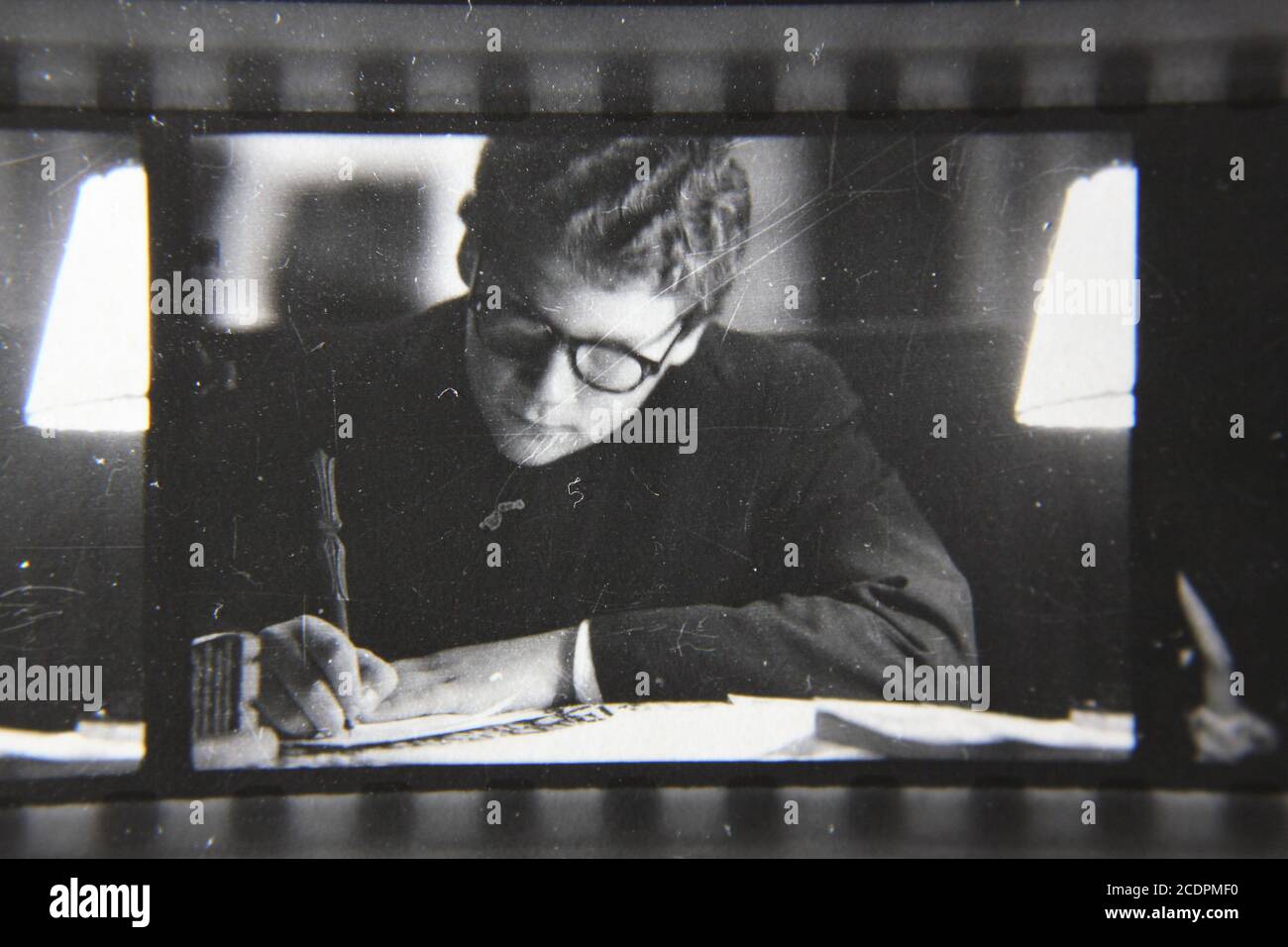 Fine 1970s vintage black and white photography of a young man writing a ...