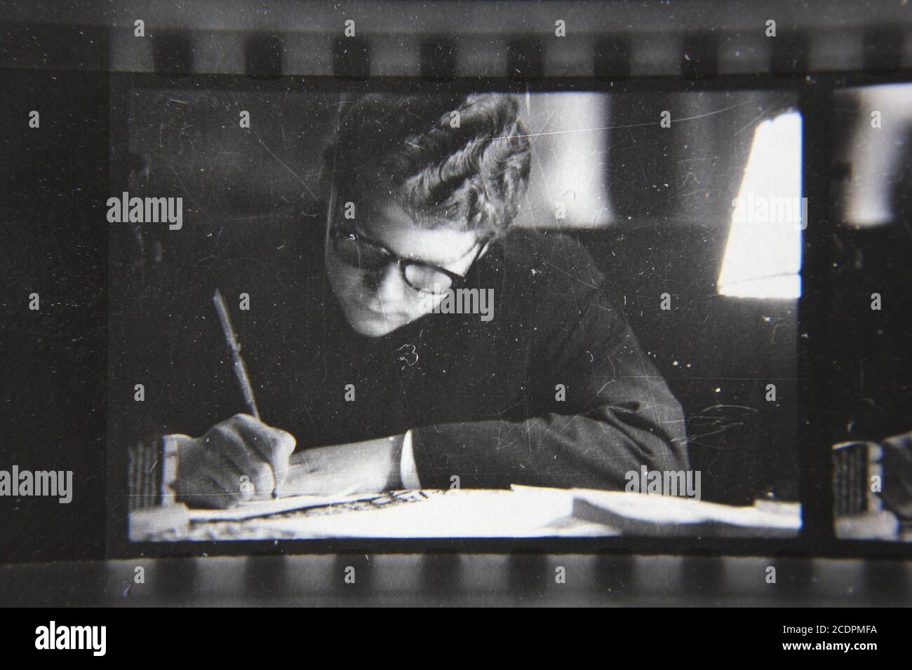 Fine 1970s vintage black and white photography of a young man writing a ...