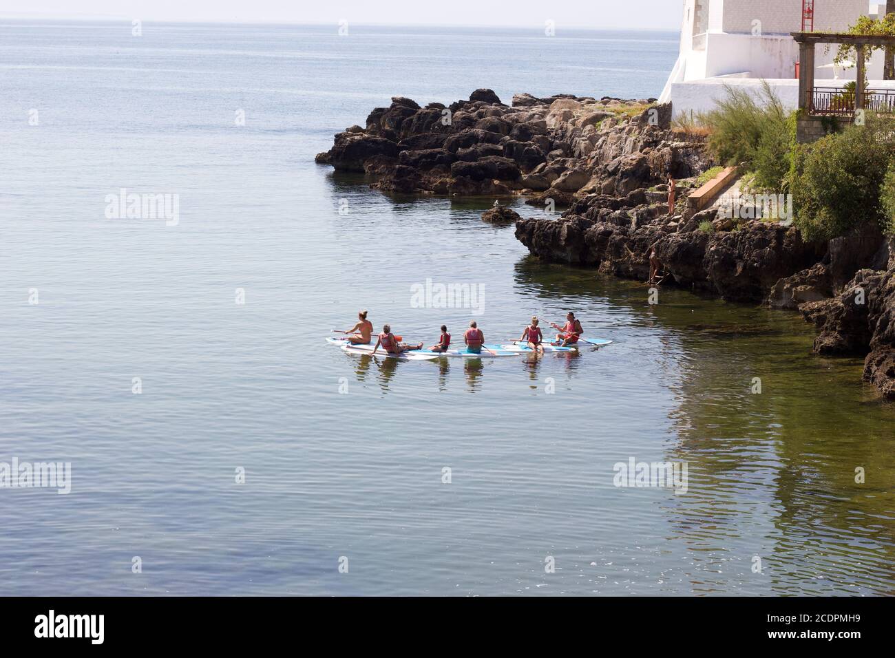 SUP touring family near the lighthouse in Atlantic ocean Stock Photo ...
