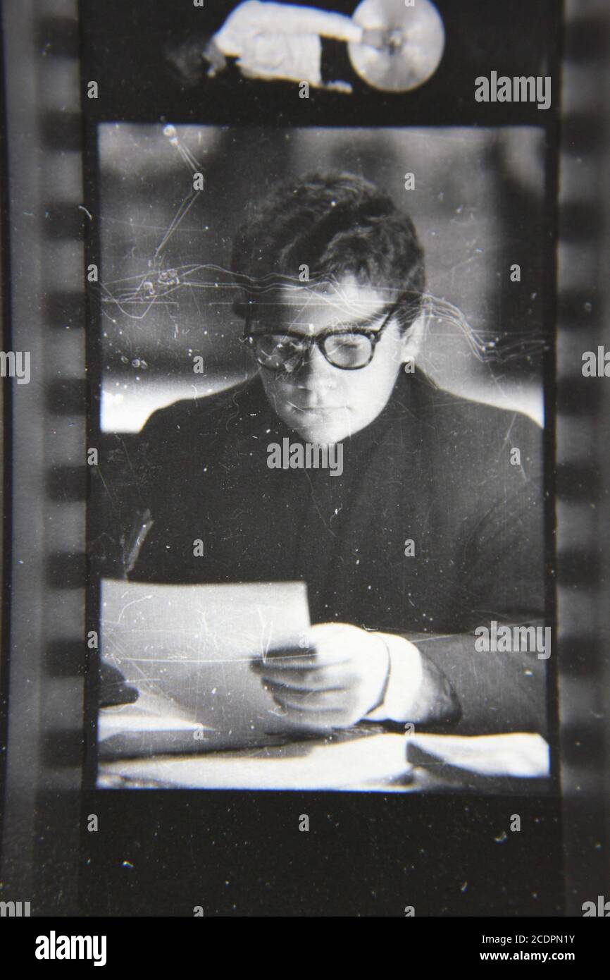 Fine 1970s vintage black and white photography of a young man writing a ...