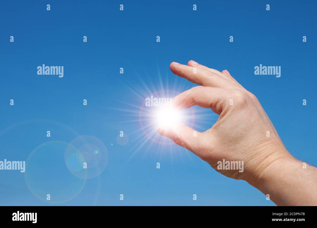 Mans hands holding sun rays Stock Photo - Alamy
