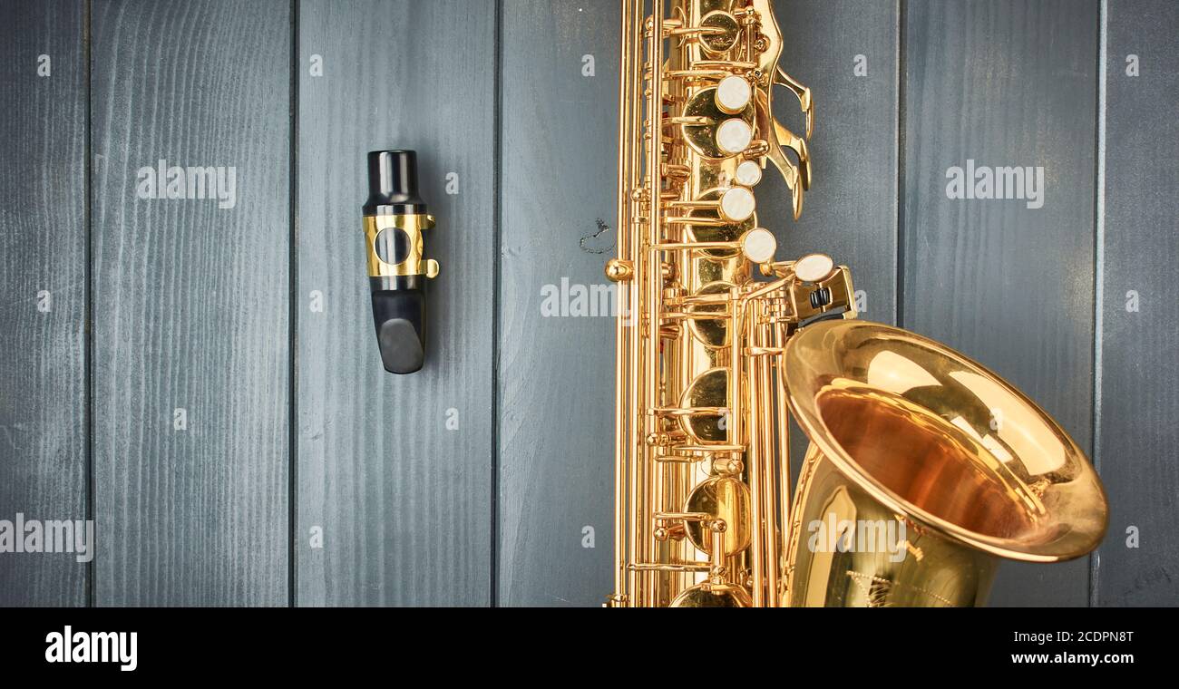 Saxophone mouthpiece disassembled from the body of the instrument, with ...