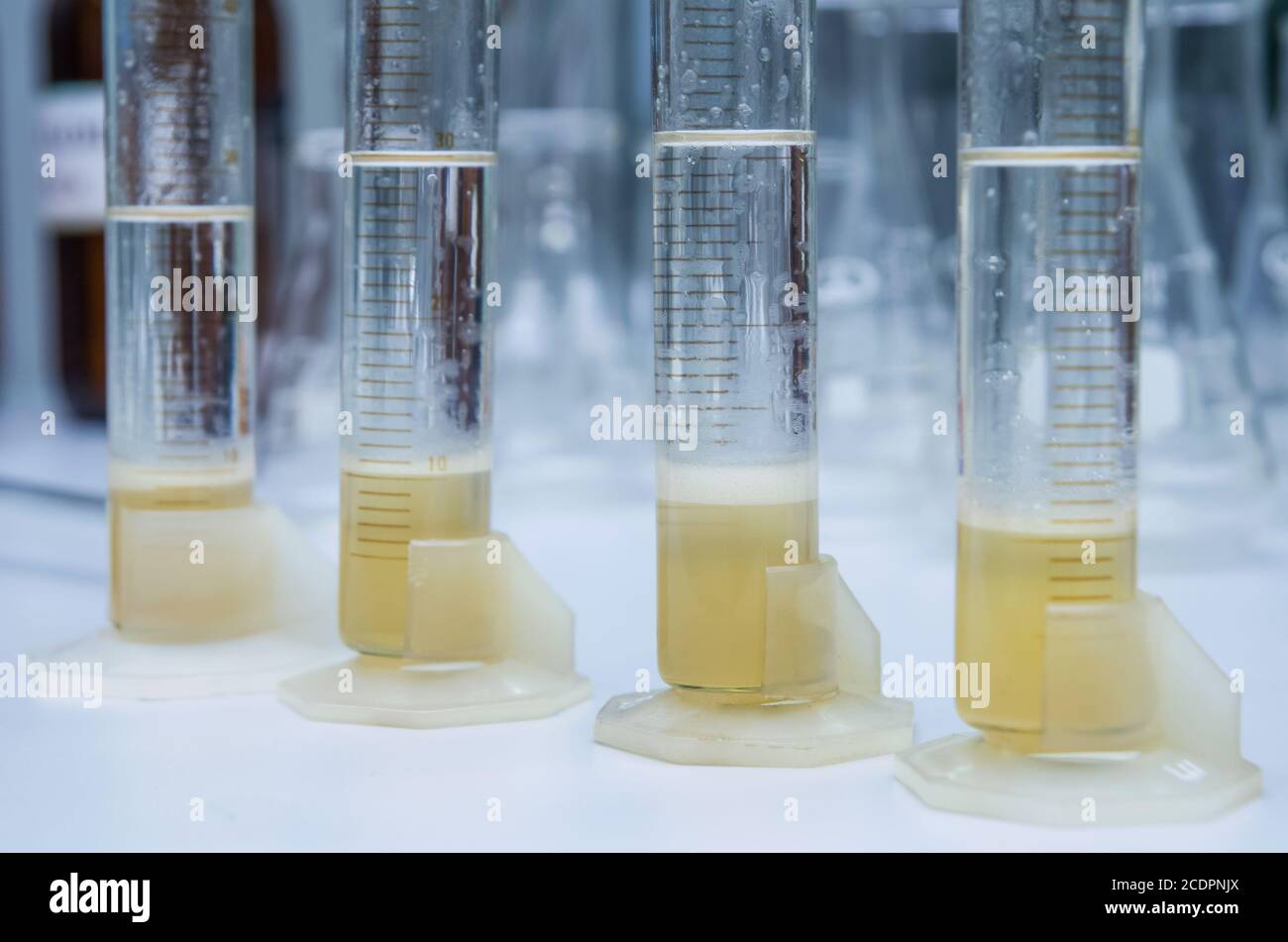 Laboratory glassware with liquids. Flasks with two-phase liquid Stock ...