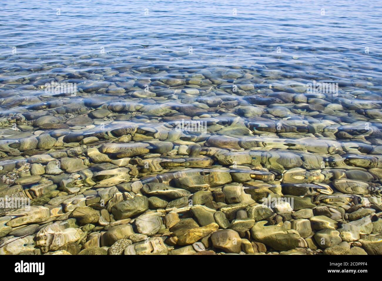 Pebbles Under Clear Blue Sea in Corfu Stock Photo - Alamy