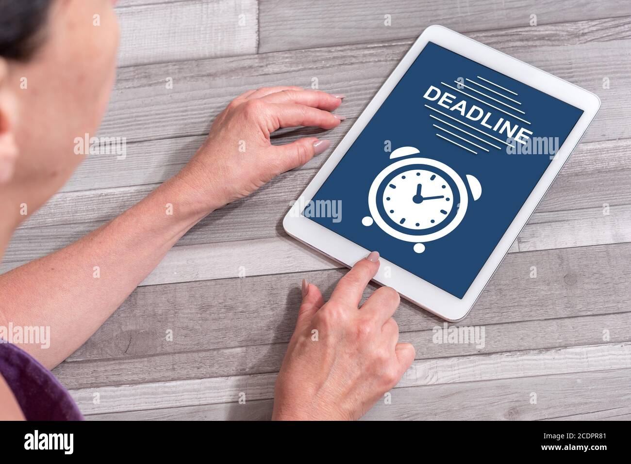 Woman using a tablet showing deadline concept Stock Photo - Alamy