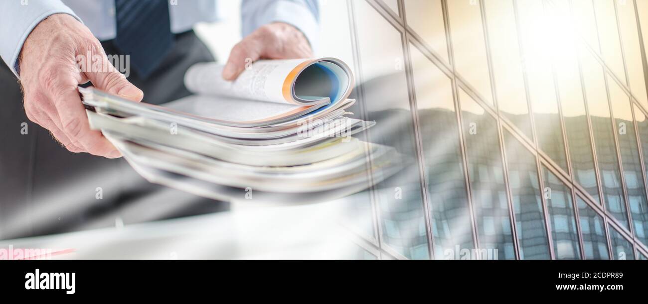 Businessman holding magazines at office; multiple exposure Stock Photo ...