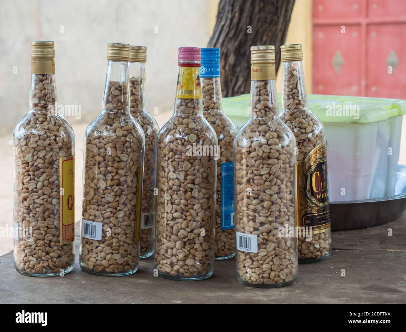 Nianing, Senegal - January 2019: Peanuts sold in glass bottles of a ...