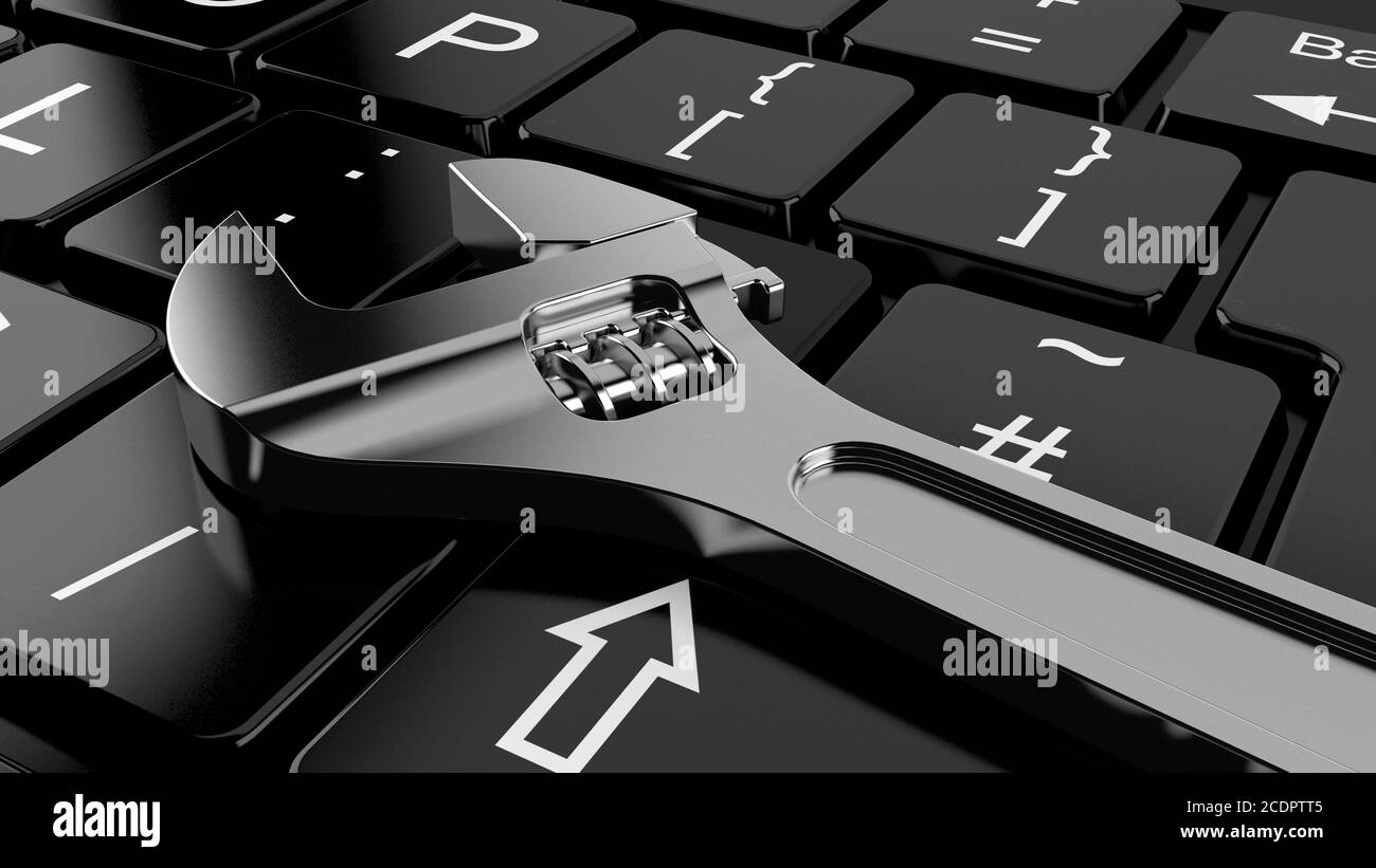 Adjustable wrench lying on computer keyboard Stock Photo - Alamy