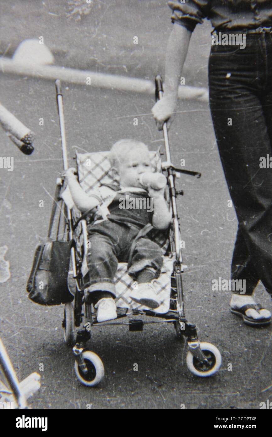 Fine 1970s vintage black and white photography of a young baby taking a ...