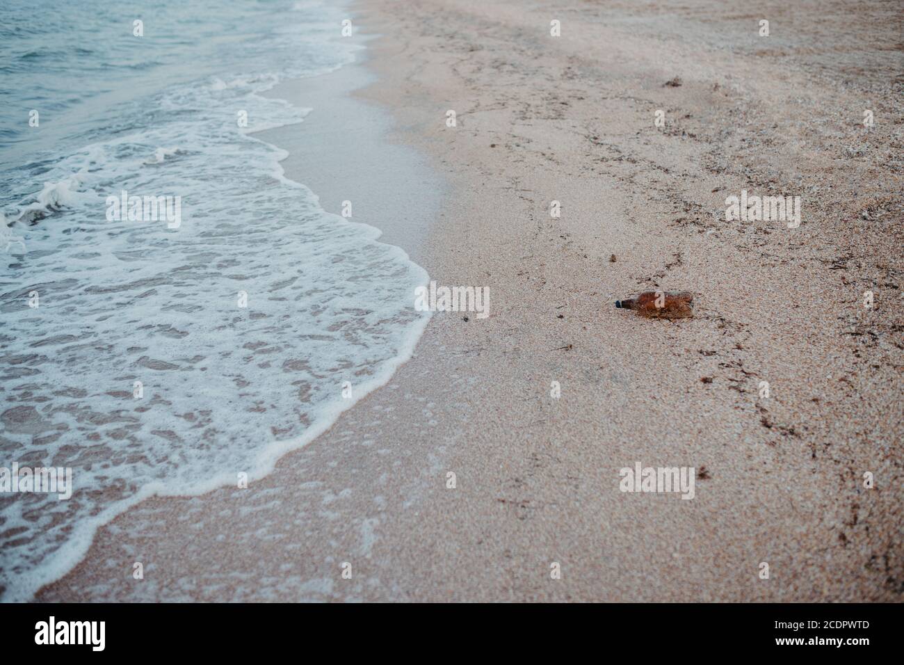 Beautiful seascape and opposite side discarded plastic pet bottle lying ...