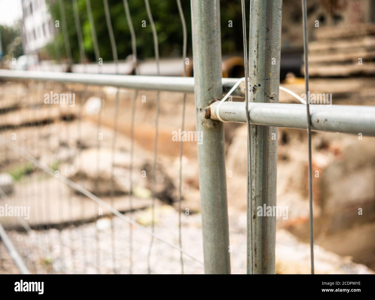 Selective focus of fence around trench with insulated water pipes and ...