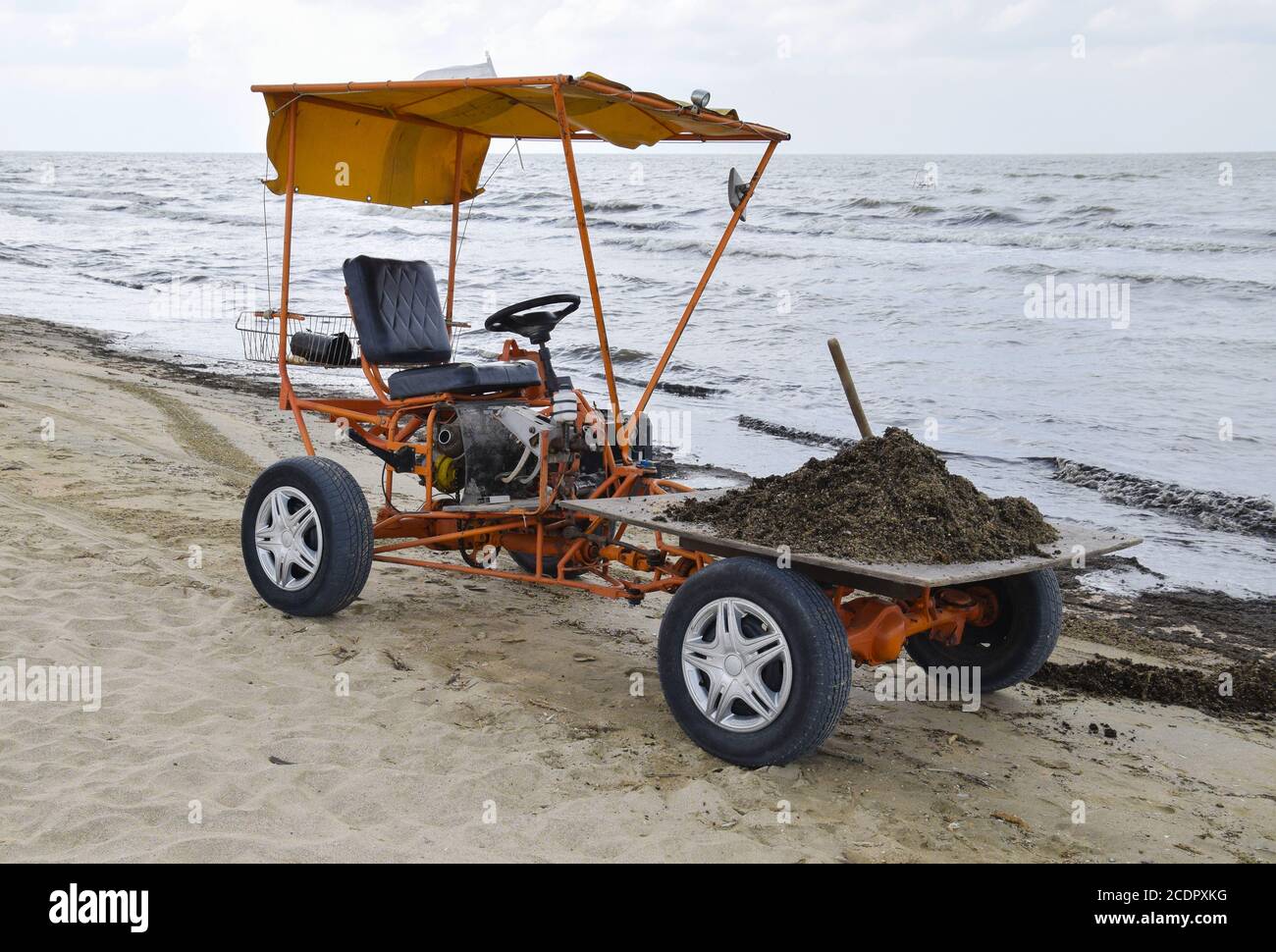 The car for garbage collection from the beach. Cleaning on the beach ...