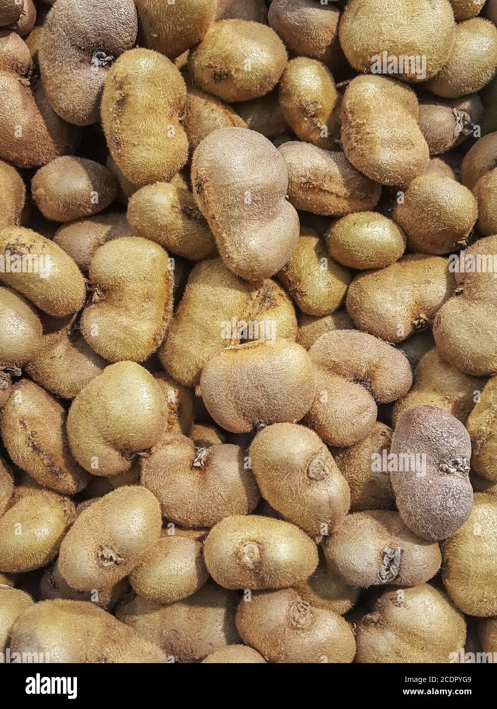 Fresh kiwi fruit in boxes on display at market, background Stock Photo ...