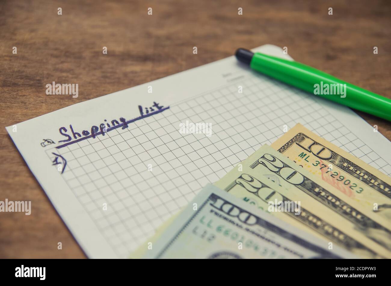 Cash, a sheet of paper and a pen, shopping list Stock Photo - Alamy