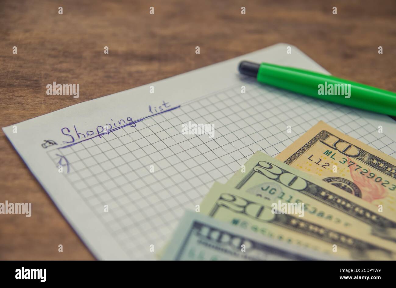 Cash, a sheet of paper and a pen, shopping list Stock Photo - Alamy
