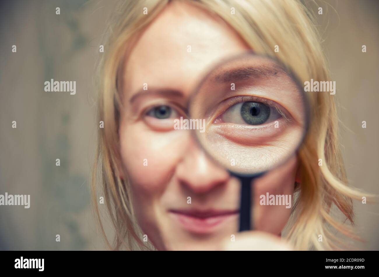The woman with a magnifier in a hand Stock Photo - Alamy