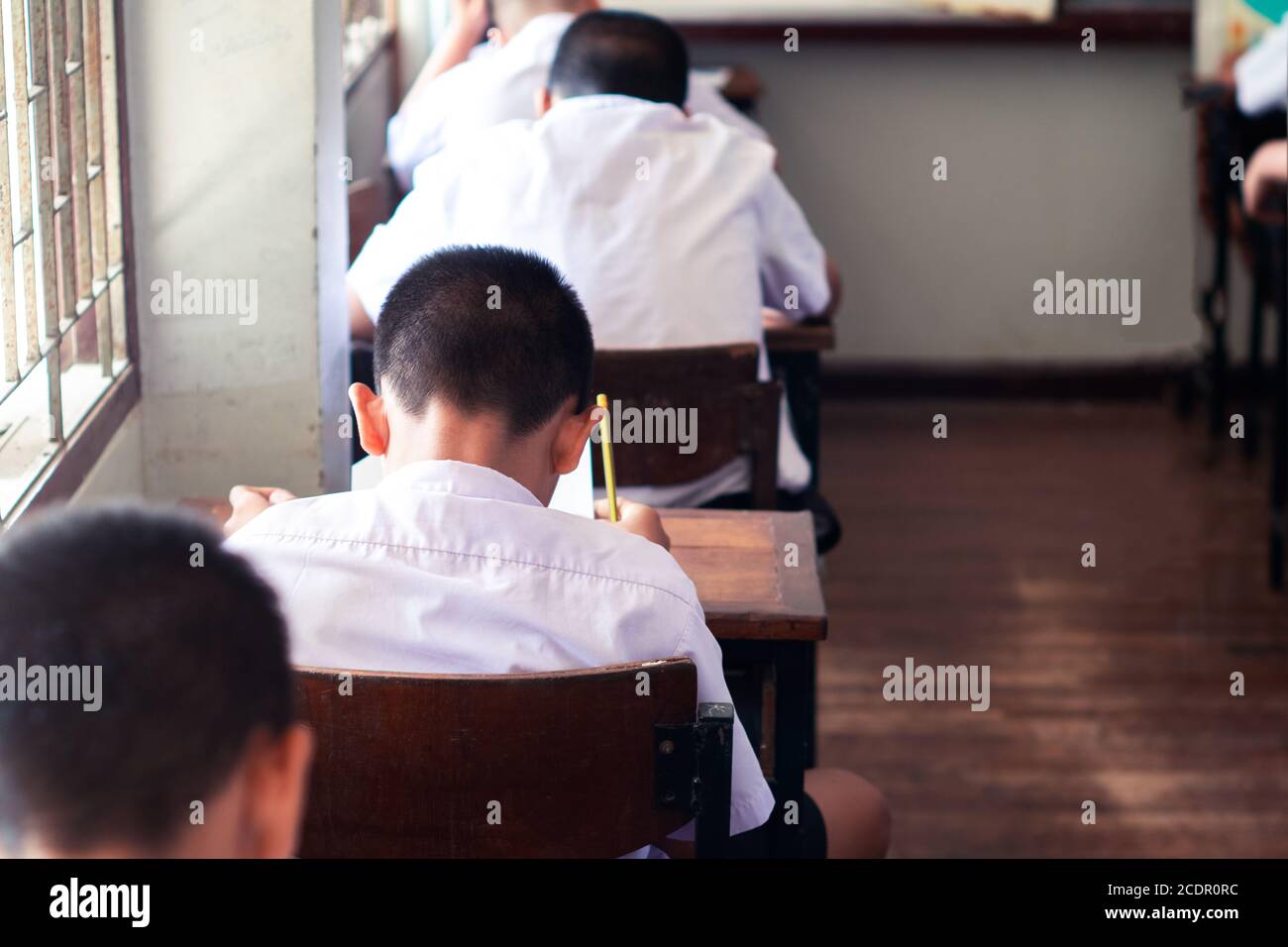 students writing and taking exam with stress in classroom Stock Photo ...