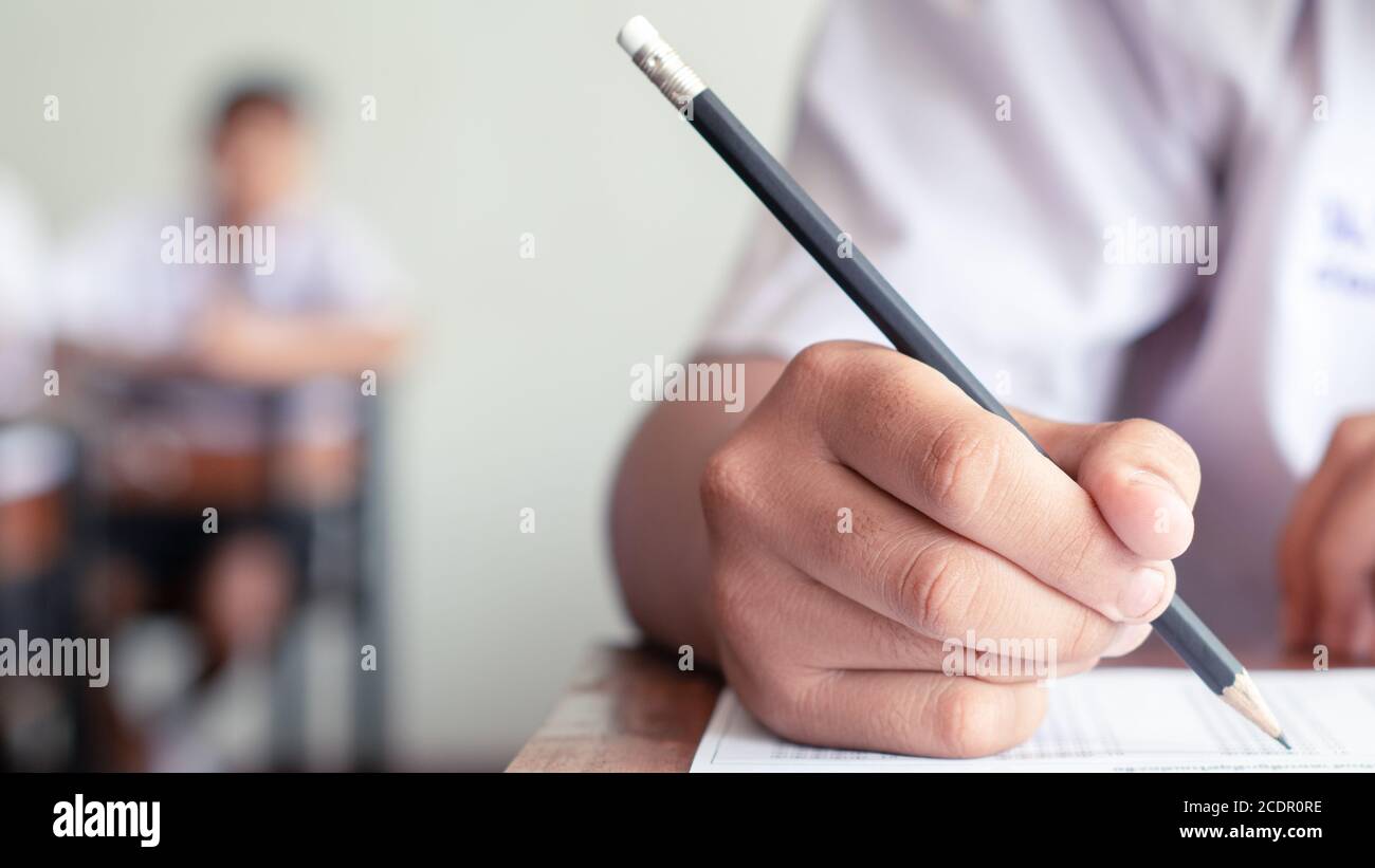 Hand of students writing and taking exam with stress in classroom.16:9 ...