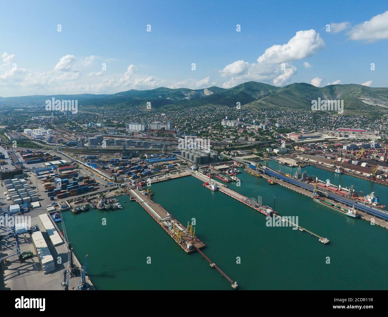 Industrial seaport, top view. Port cranes and cargo ships and barges ...