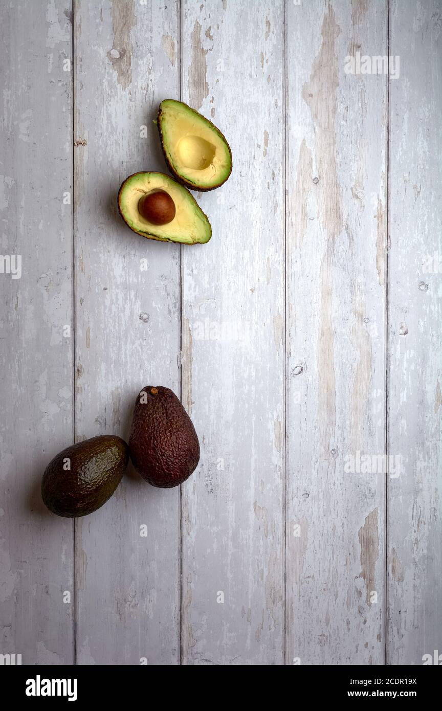 set of avocados, cut and uncut, on a clear background of deteriorated ...
