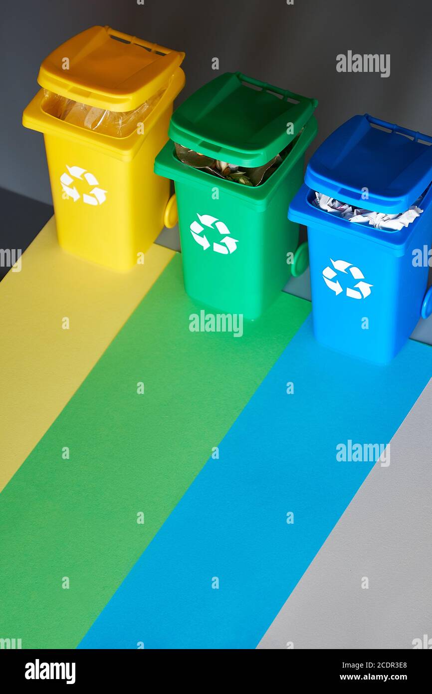 Three color coded recycle bins, isometric picture on geometric layered ...