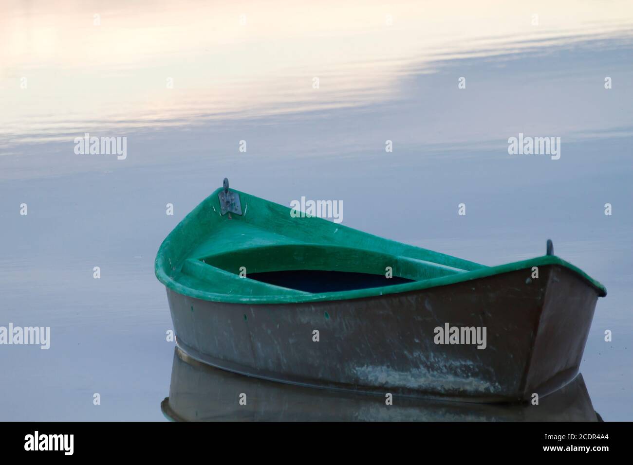 Empty rowboat in water hi-res stock photography and images - Alamy
