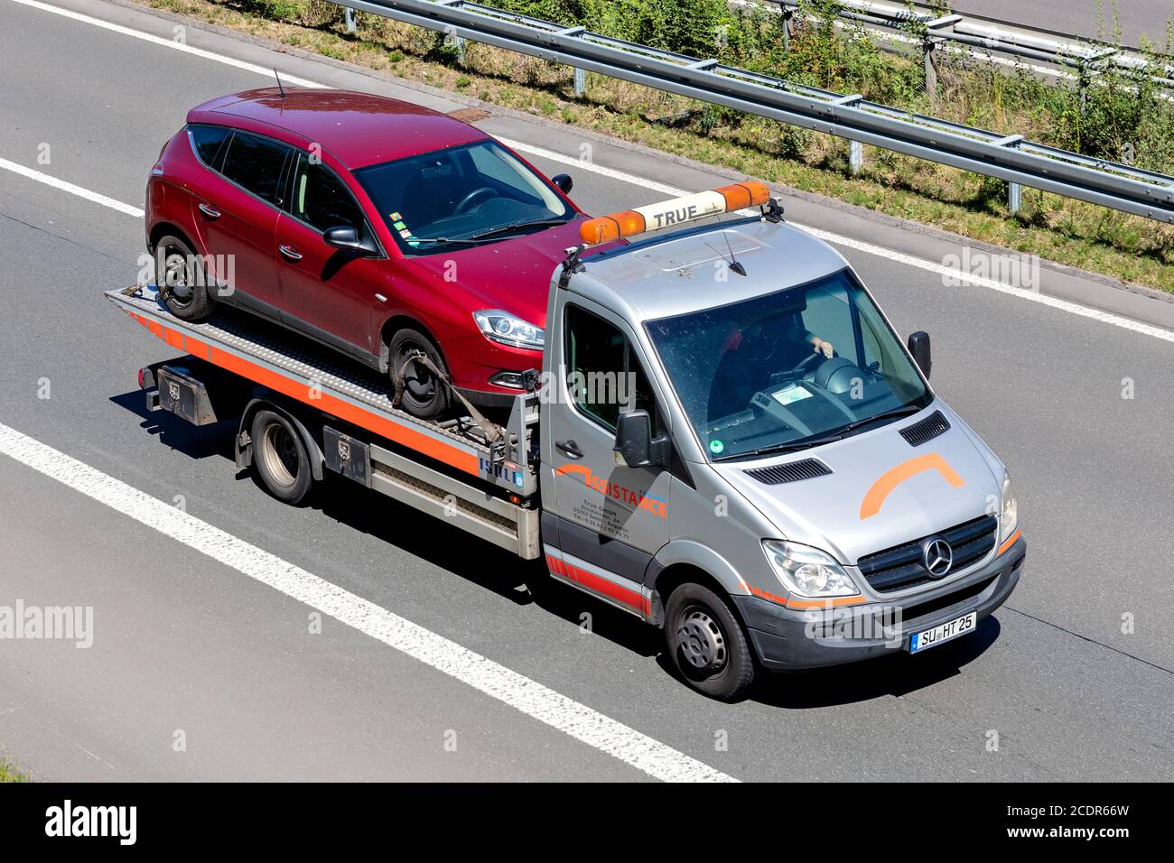 Assistance Partner flatbed recovery vehicle on motorway Stock Photo - Alamy
