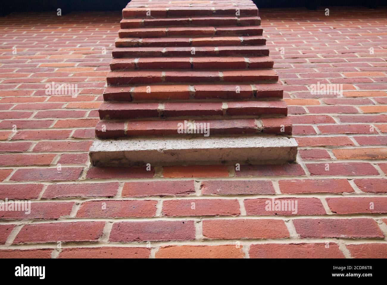 Architectural feature of stepped brickwork newly laid with mortar in ...