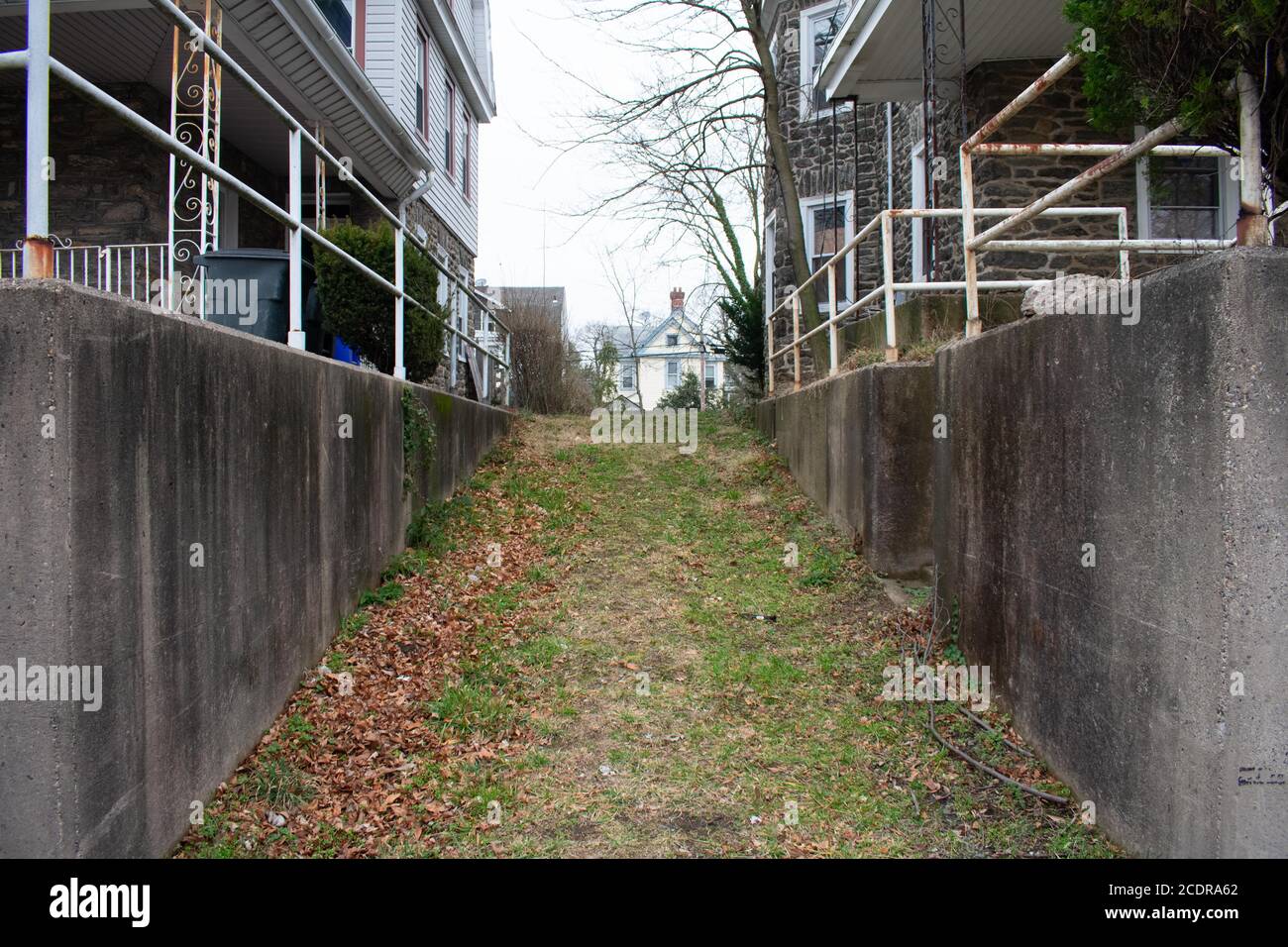 A Grass Hill Driveway Between Two Concrete Walls Stock Photo - Alamy