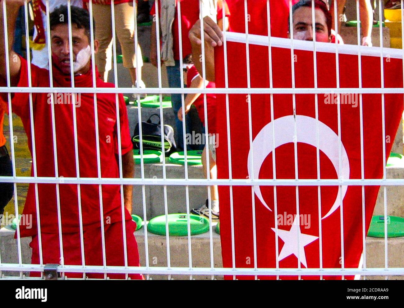 Turkish soccer fans with flag behind barrier at the stadium Stock Photo ...