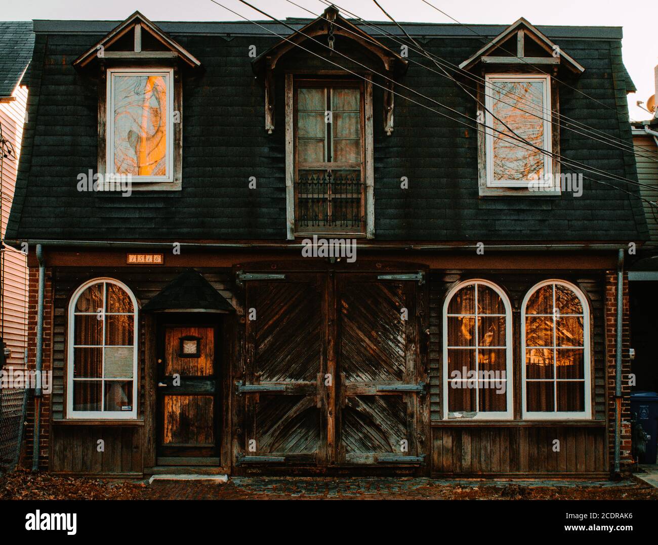 An Old Rustic House Made of Textured Wood with a Large Barn Door Stock ...