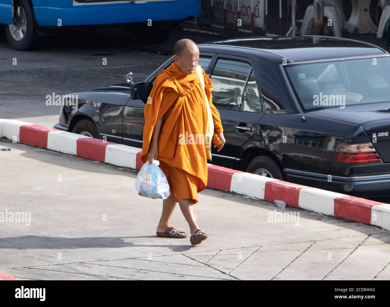 Old monk walking on street hi-res stock photography and images - Alamy