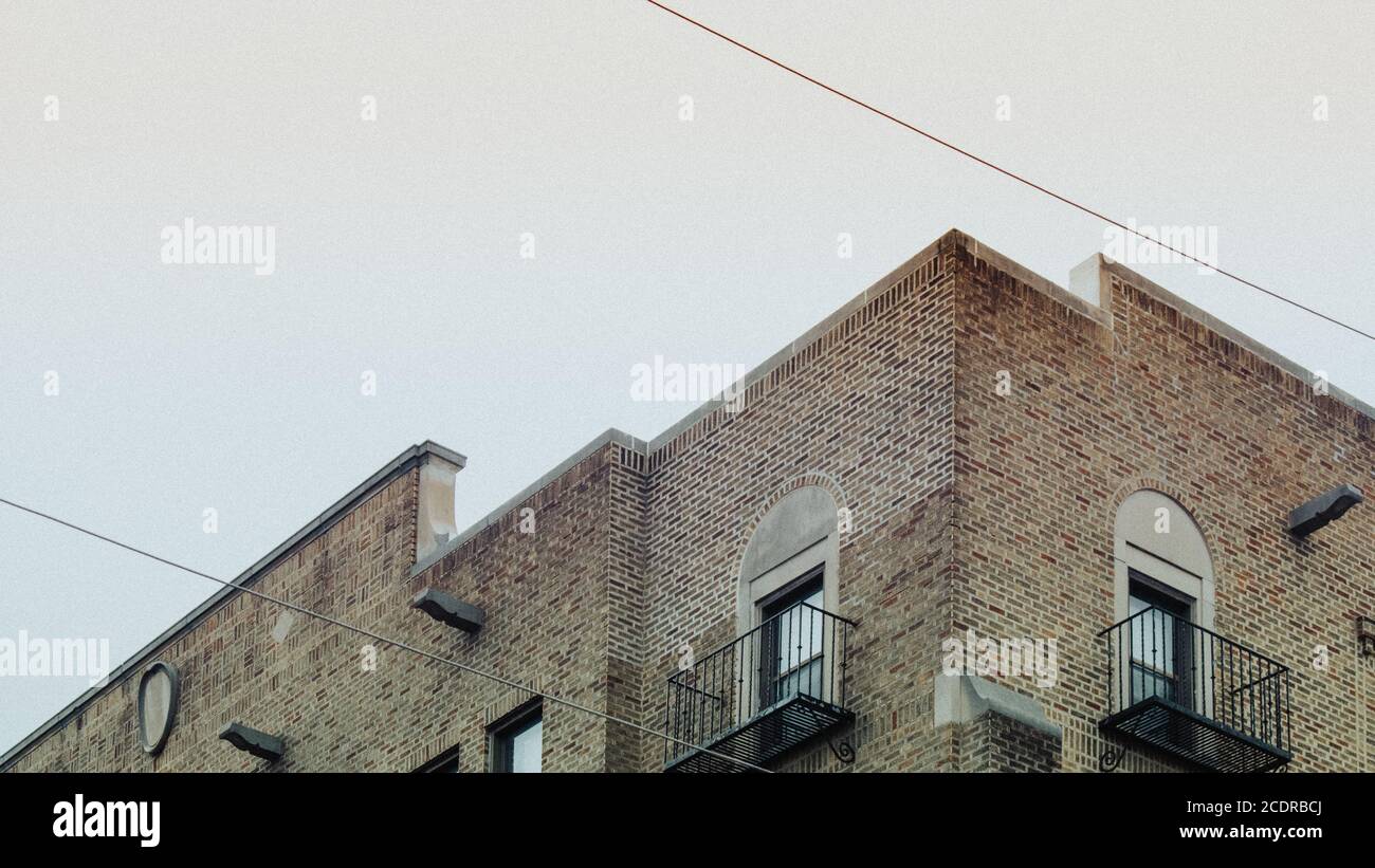 The Top of an Old-Fashioned Brick Apartment Building on a Gray Overcast ...