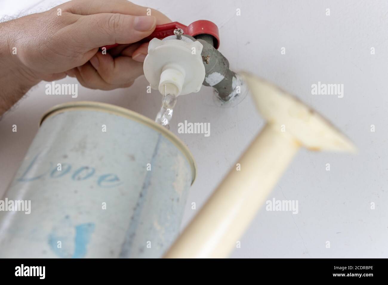 Water from a faucet flowing to the ewer, view from below. Stream of ...