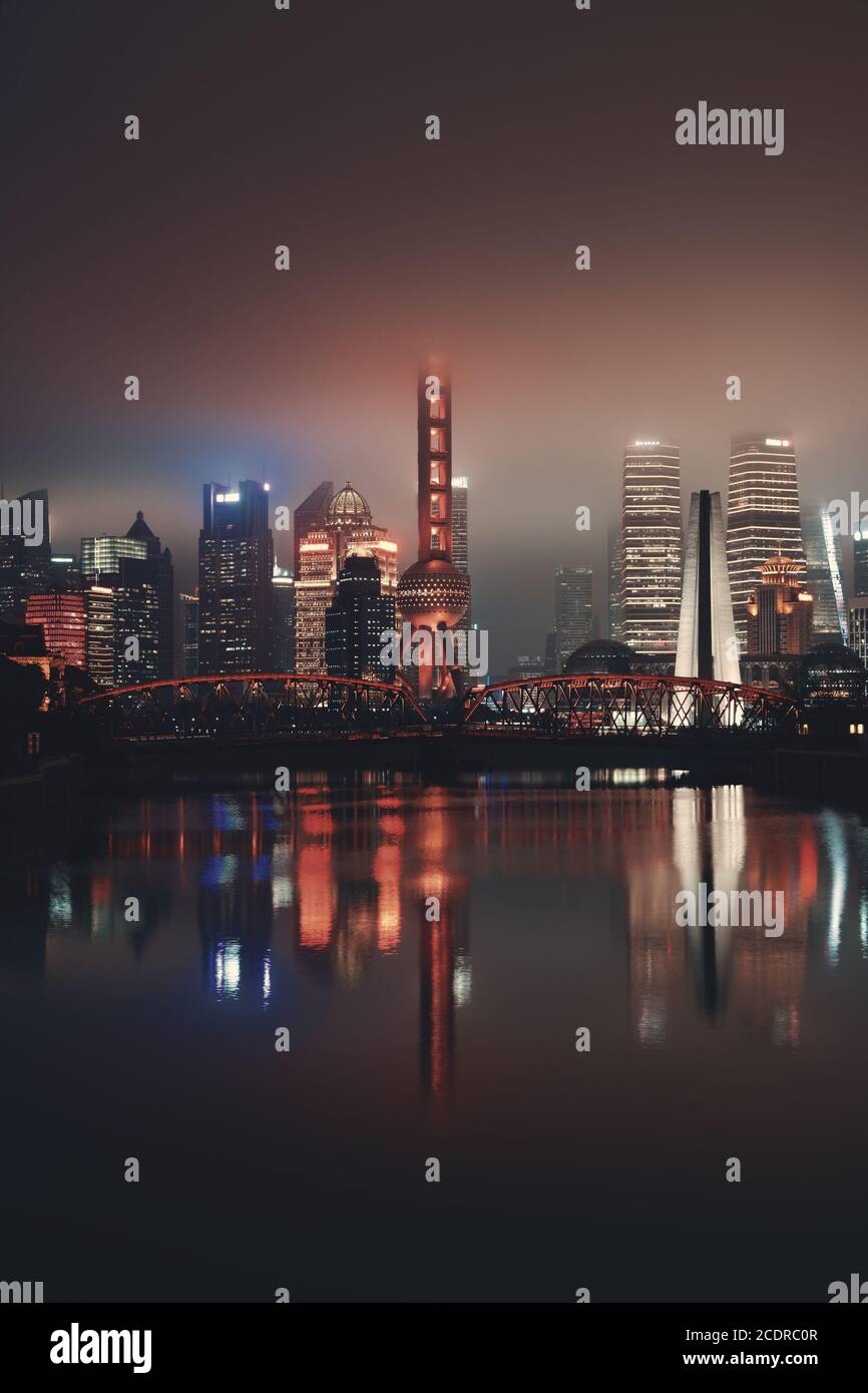 Shanghai city night view with skyscrapers and water reflections in ...