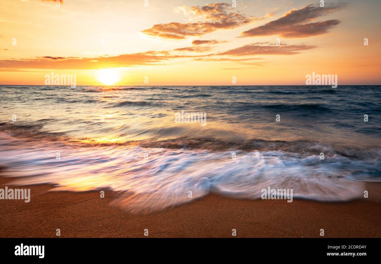 Landscape with sea sunset on beach Stock Photo - Alamy