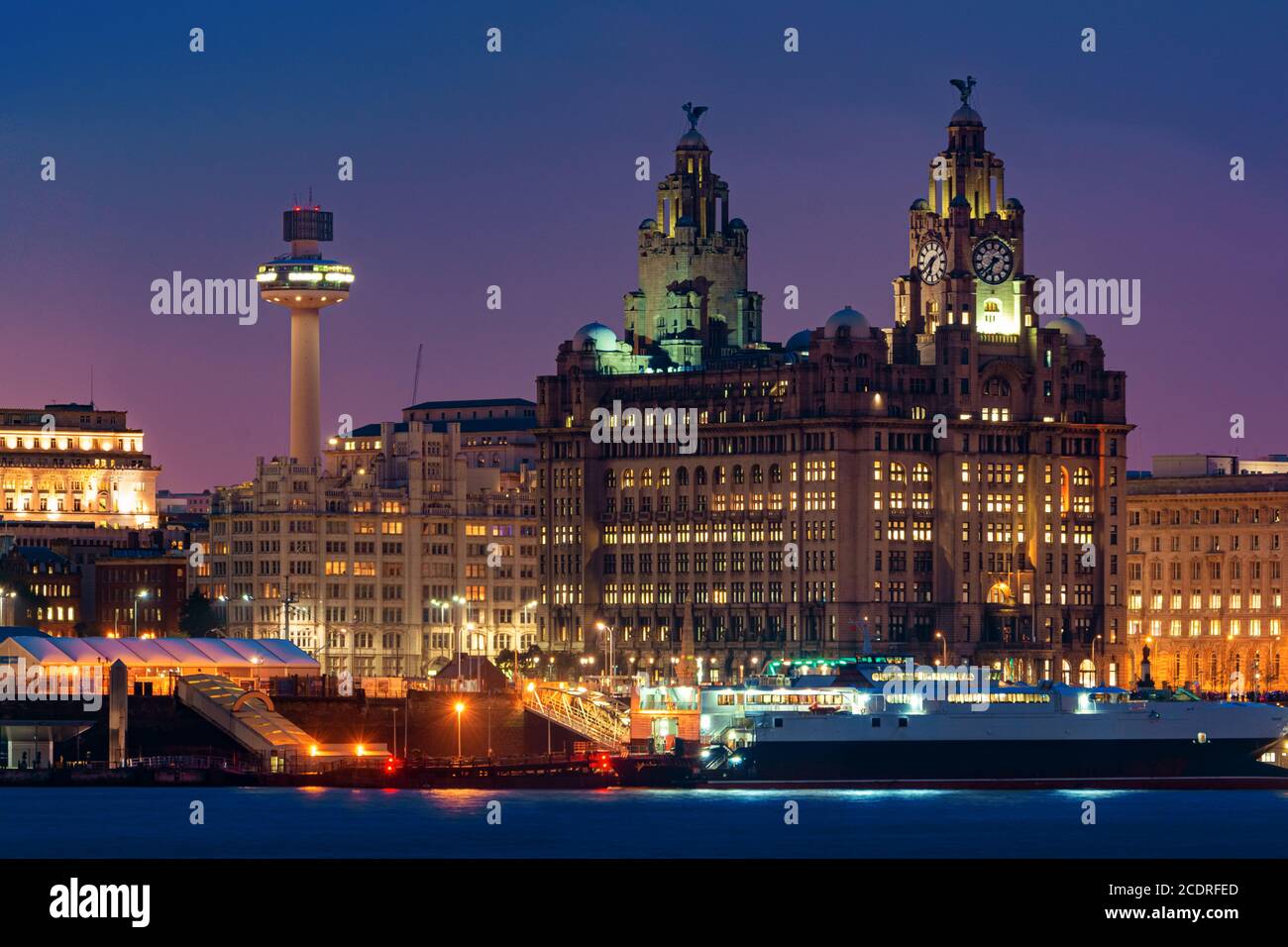 Liverpool Royal Liver Building at night with buildings in England in ...