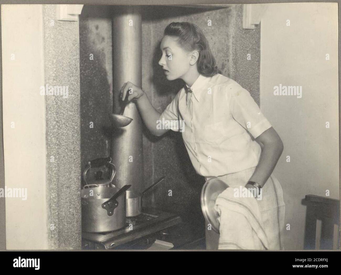 Domestic study of Irina Baronova cooking, Ballets Russes, ca. 1930s ...