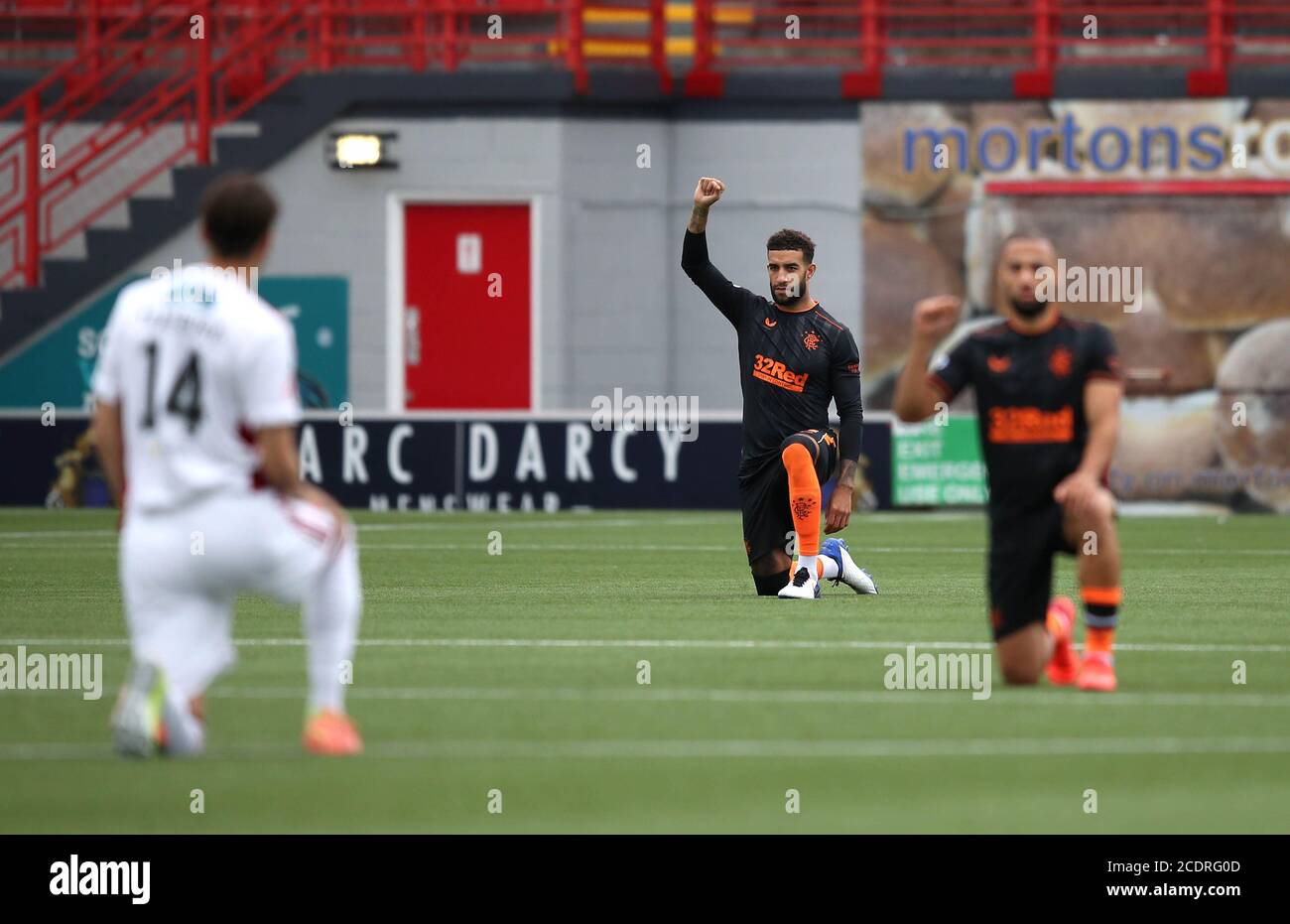 Rangers' Connor Goldson (centre) takes a knee prior to kick-off during ...