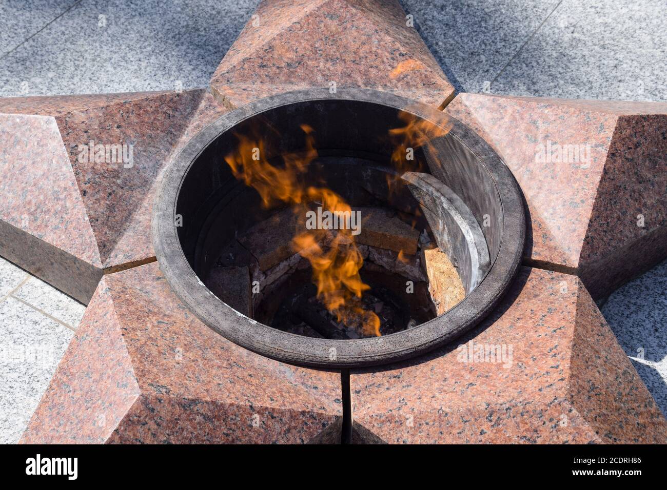 Burning of eternal fire. Five-pointed star made of granite memorial to ...