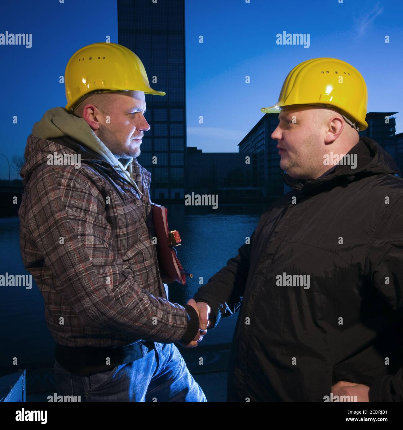 handshake with helmets Stock Photo - Alamy