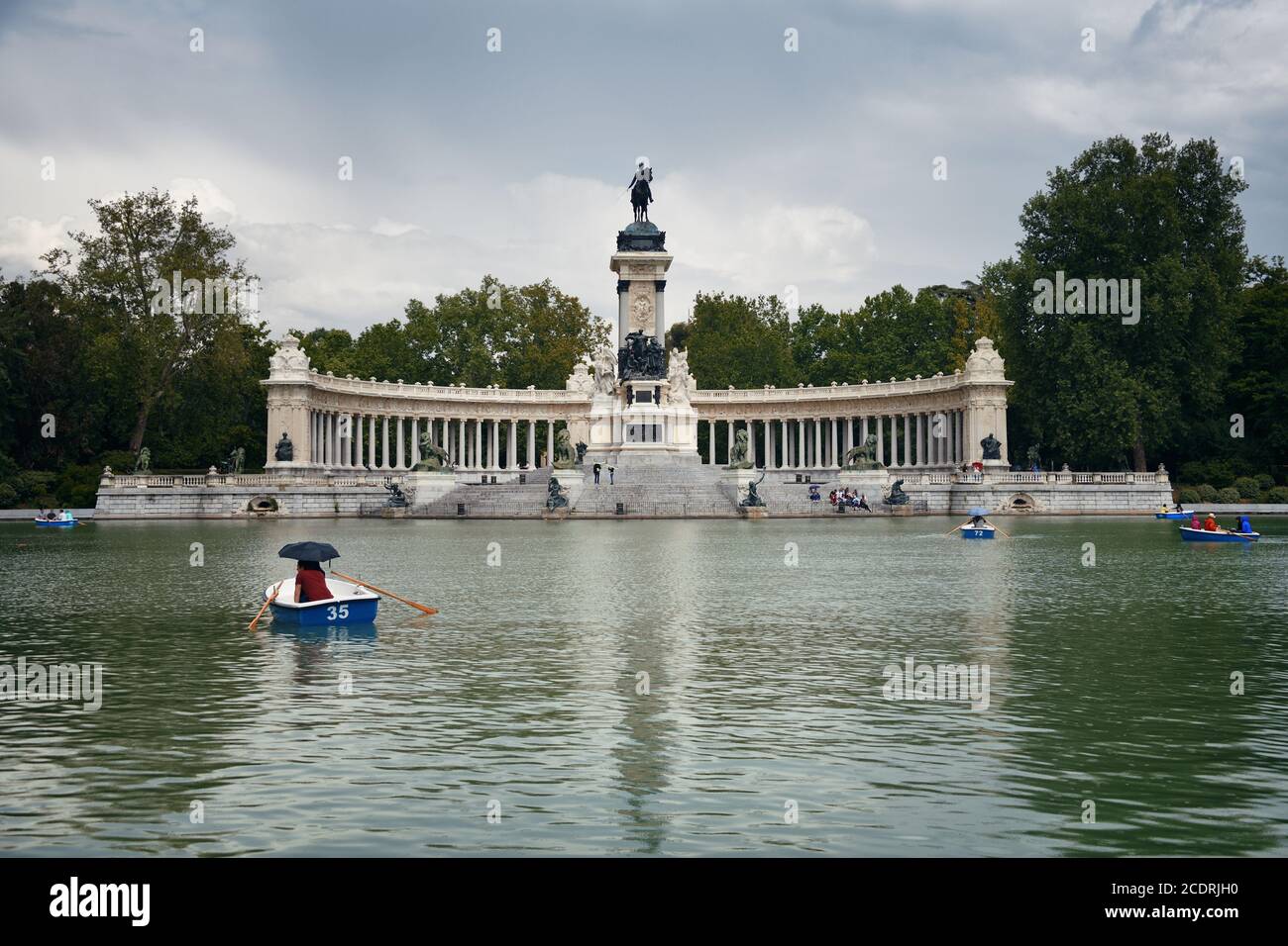 Boat in lake with Monument to Alfonso XII in El Retiro Park in Madrid ...