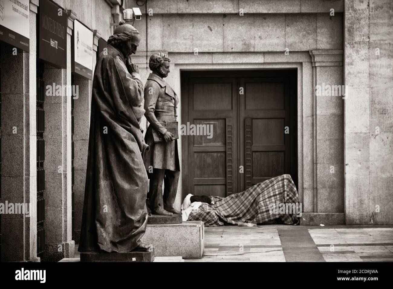 Sculpture and homeless in Madrid street in Spain Stock Photo - Alamy