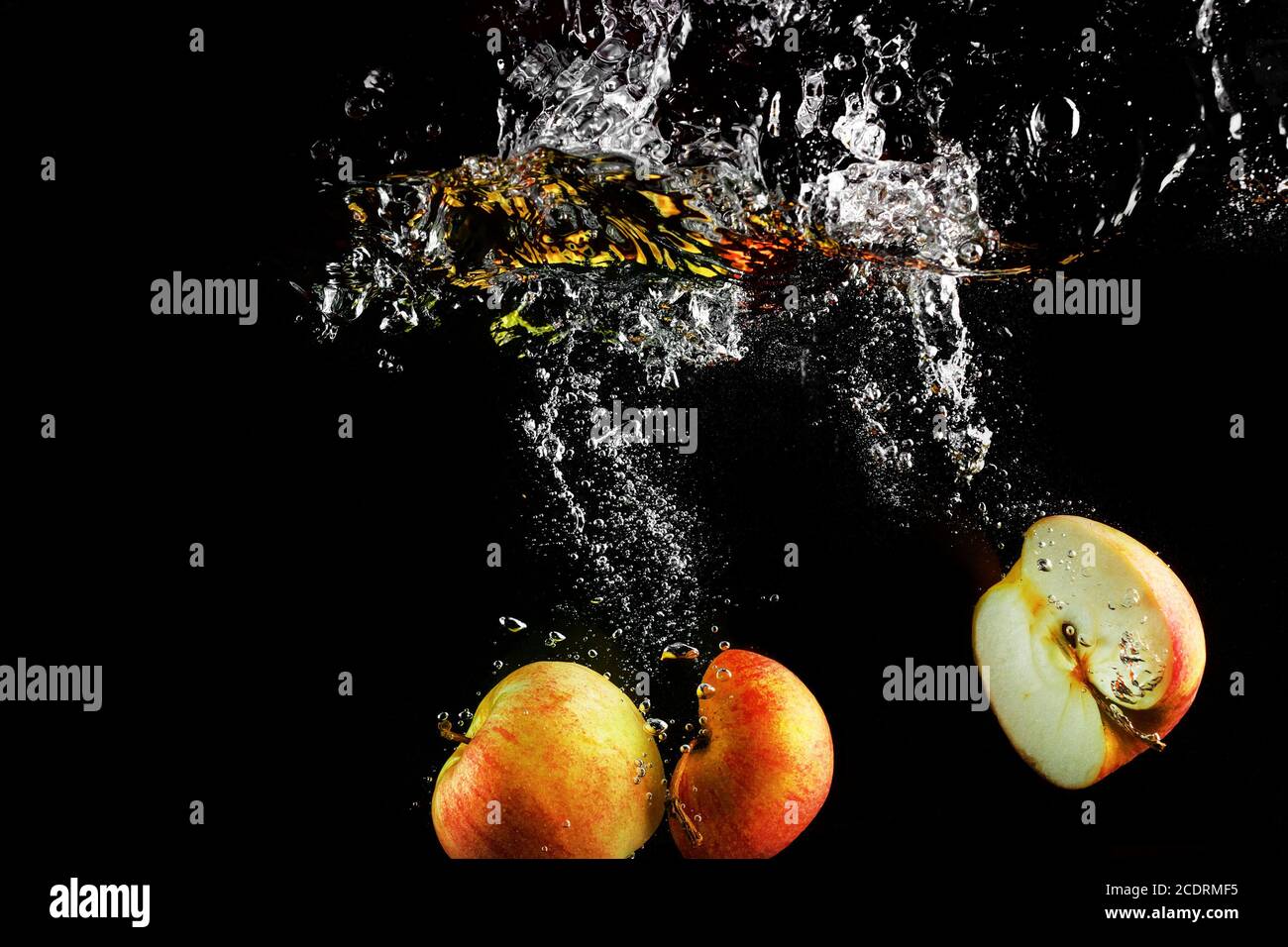 Apples falling into water Stock Photo - Alamy