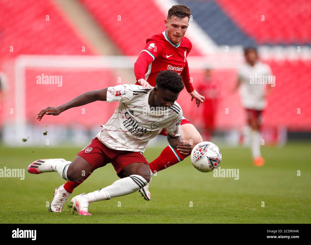 Arsenal's Bukayo Saka reacts to a challenge from Liverpool's Andrew ...