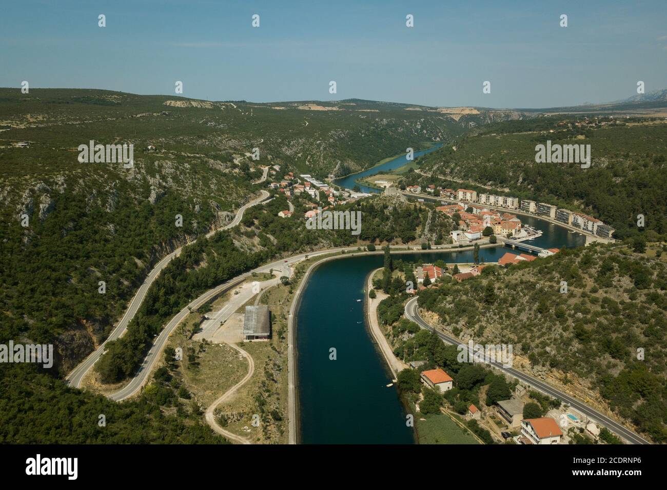 An aerial view of the ruins of the fortified city on a hill above ...