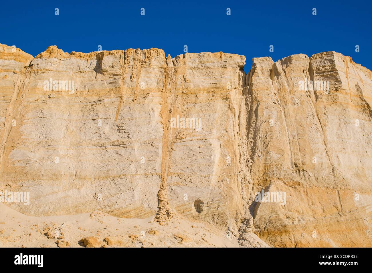 cliff of the yellow orange brown sand soil clay under the bright sunny ...