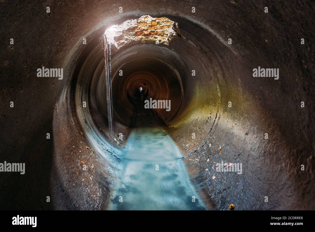 Industrial wastewater and urban sewage flowing through round sewer pipe ...